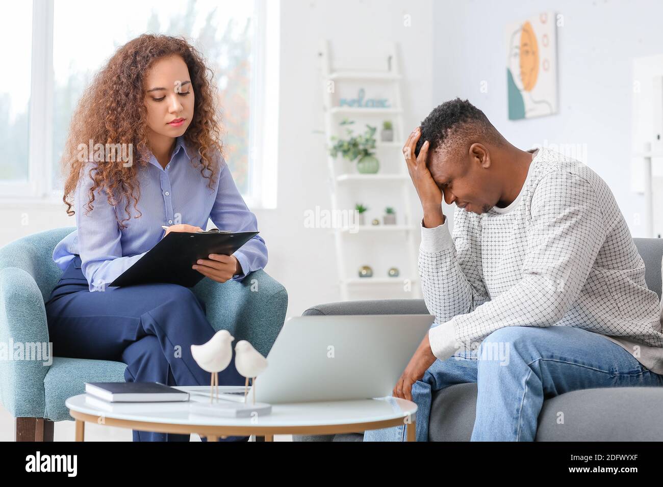 Psychologist working with African-American man in office Stock Photo ...