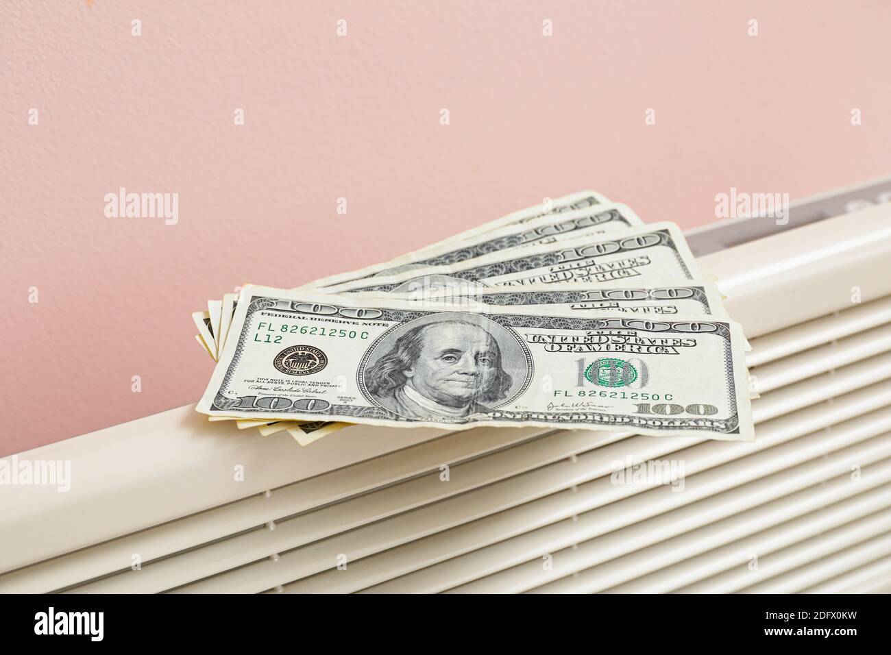 Dollar banknotes on radiator, closeup. Concept of heating season Stock ...