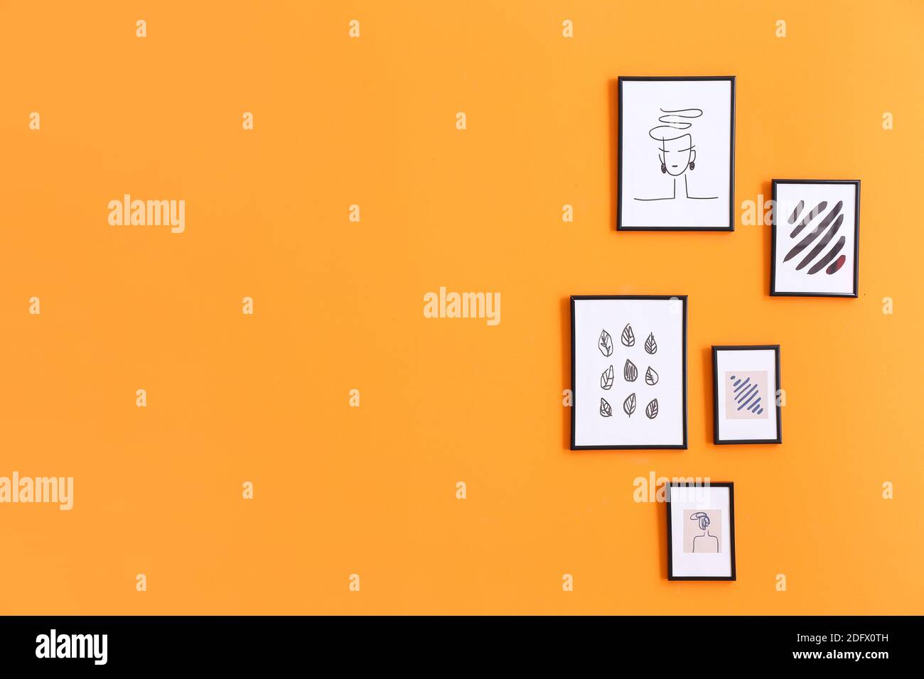 Beautiful pictures hanging on color wall Stock Photo - Alamy