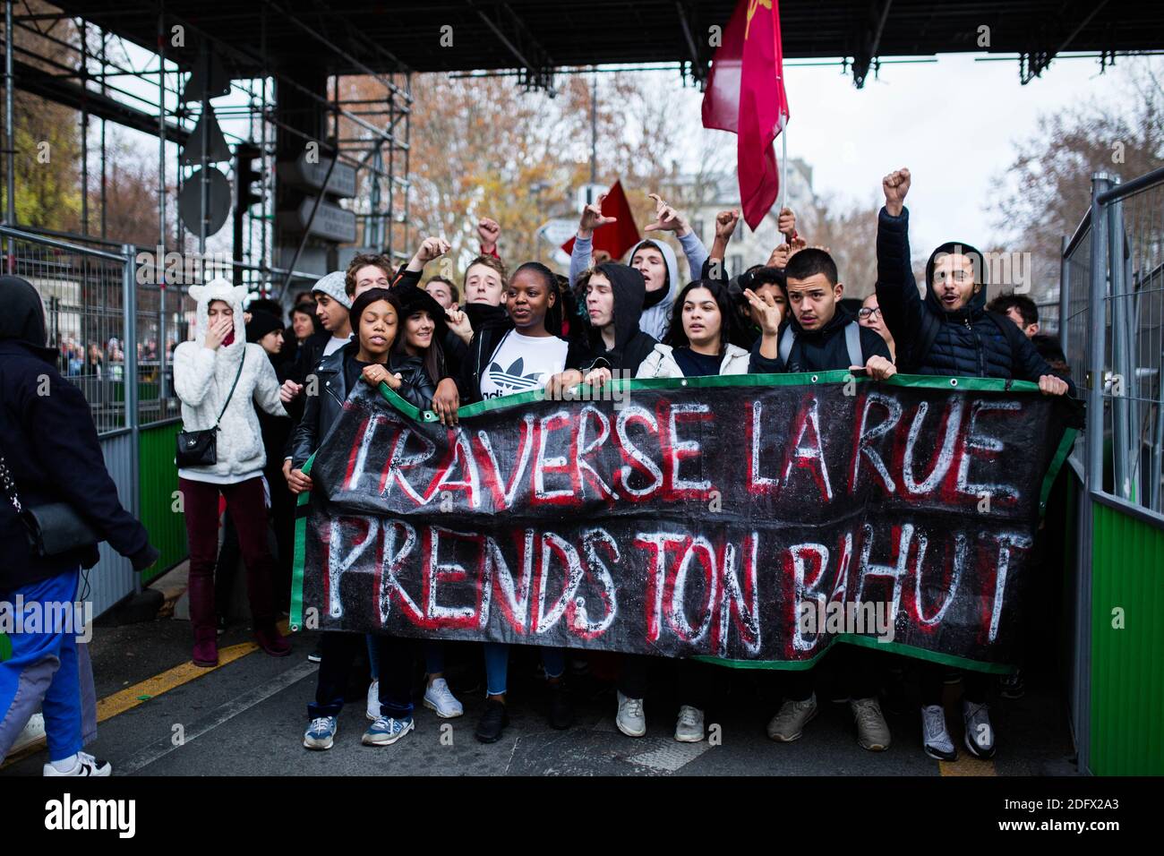 High school students chant slogans and hold a banner reading "Cross the ...