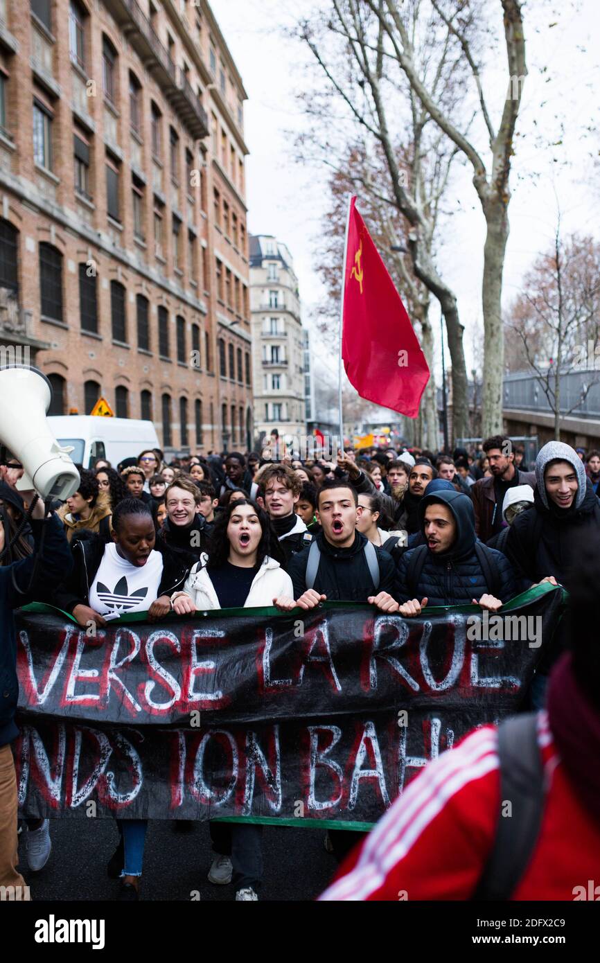 High school students chant slogans and hold a banner reading "Cross the ...