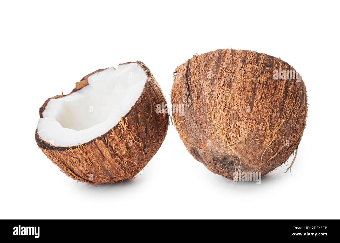Halves of ripe coconut on white background Stock Photo - Alamy