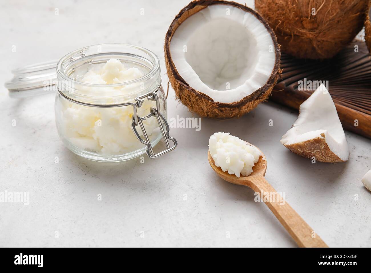Composition with coconut oil on light background Stock Photo - Alamy