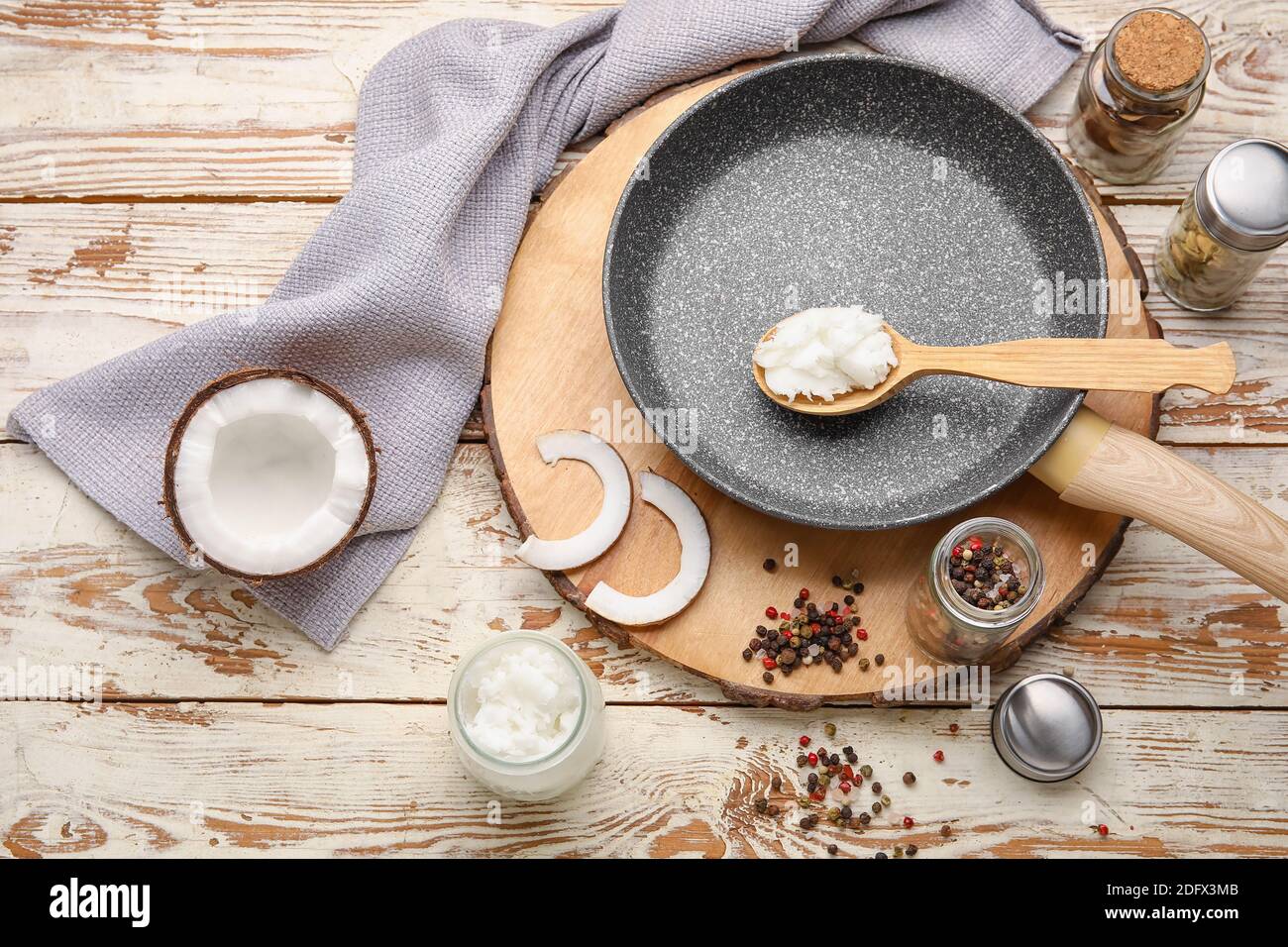 Composition with tasty coconut oil for cooking on light wooden ...