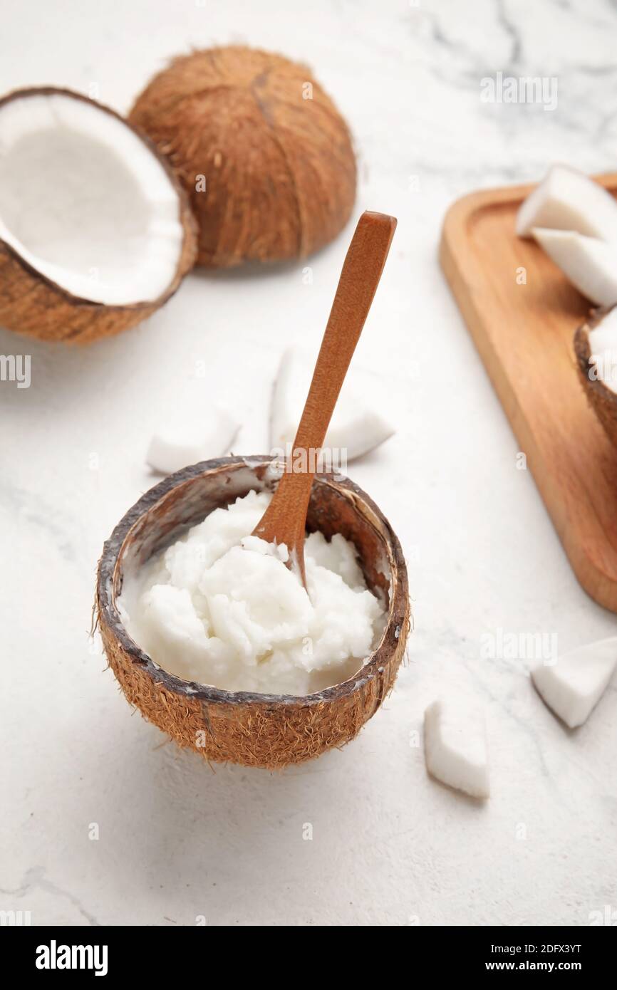 Composition with coconut oil on light background Stock Photo - Alamy
