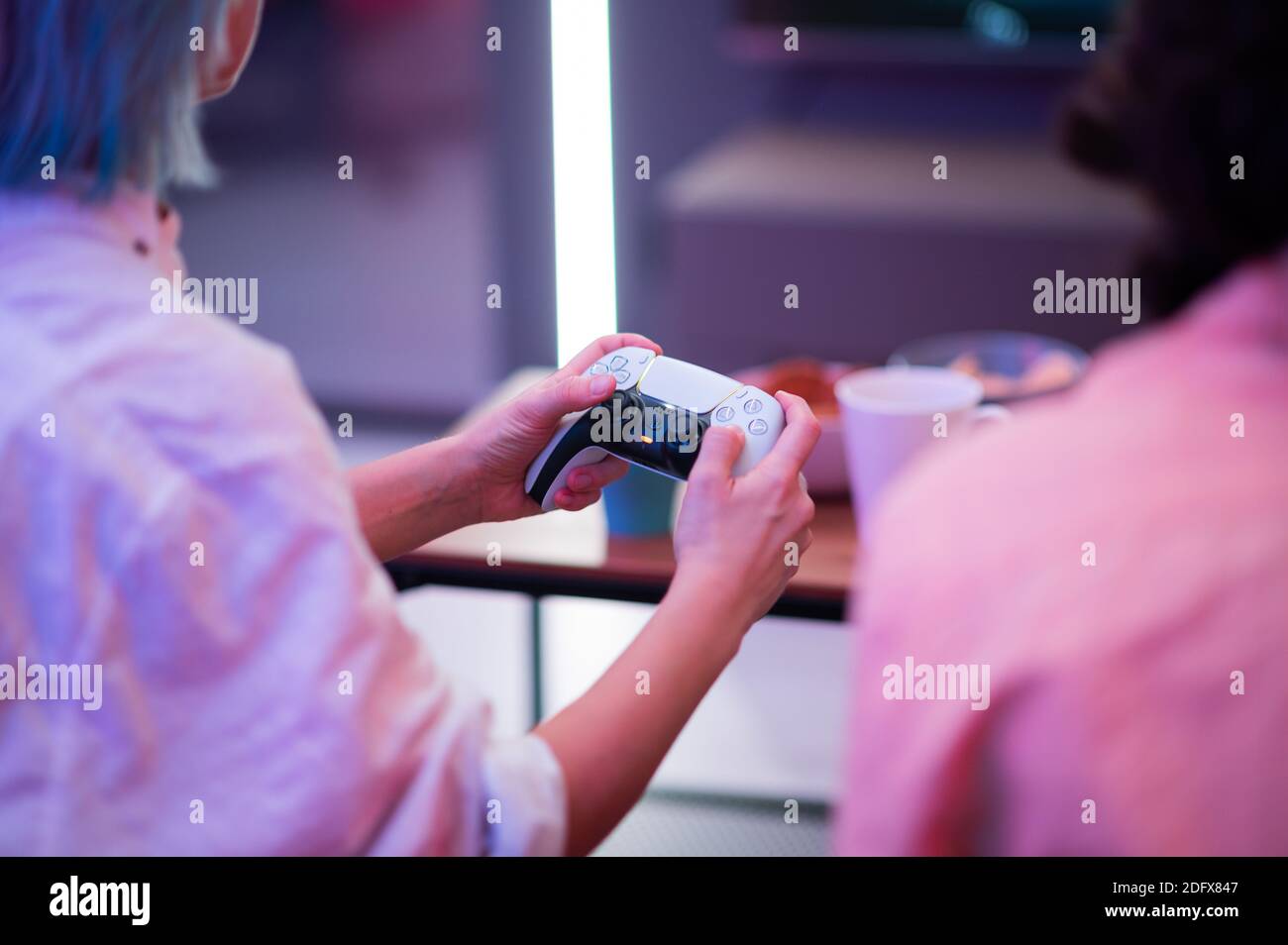 Girl using new Sony Playstation 5 DualSense wireless controller which ...