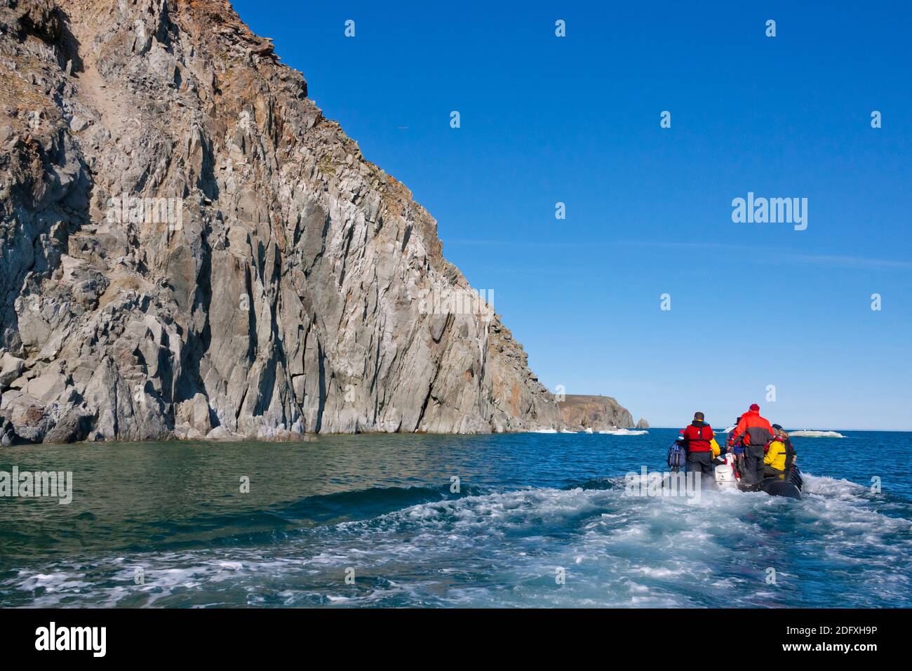 Zodiac approaching island in Cape Onman, Chukchi Sea, Russia Far East ...