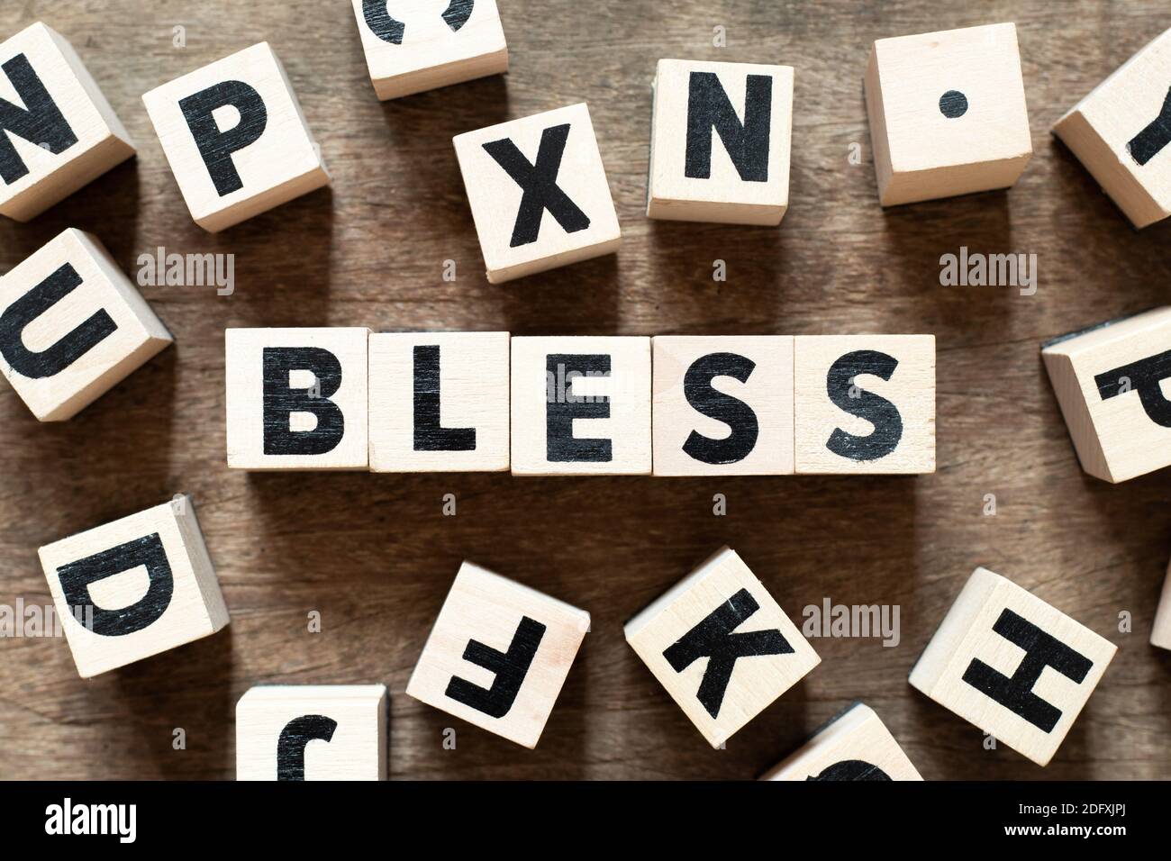 Wood letter block in word bless on wood background with another ...