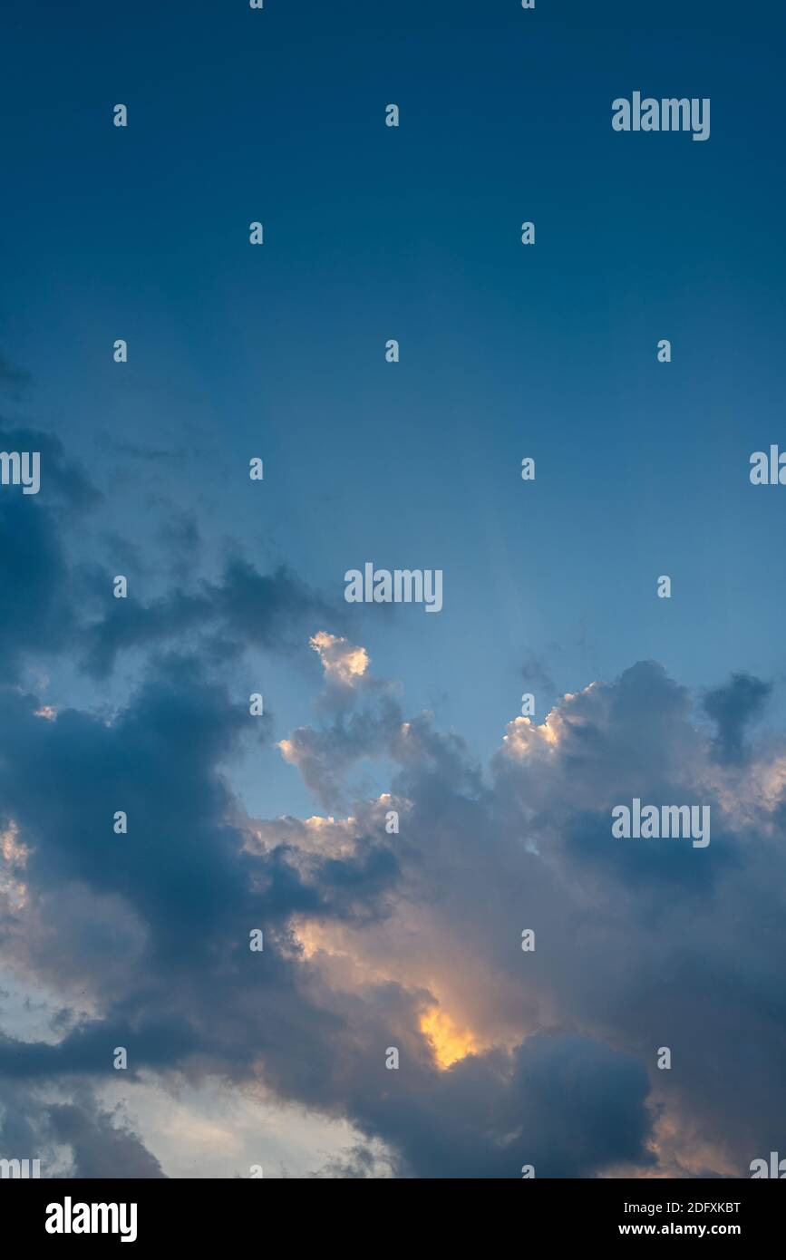 Orange sunbeam sunny cloudy sky background Stock Photo - Alamy