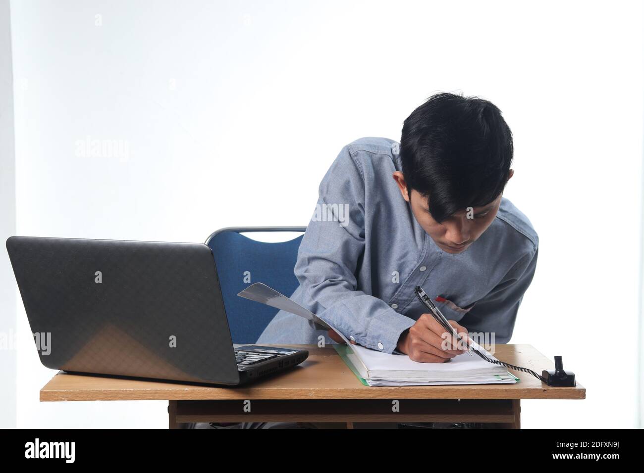 portraits of Asian men seriously working on reports on computers and ...