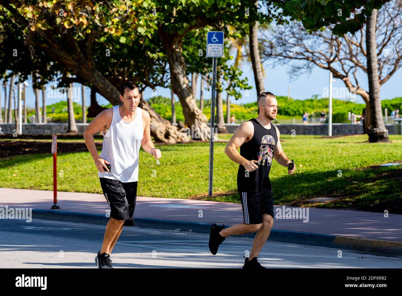 Two men running on Ocean Drive Miami Beach action shot street ...