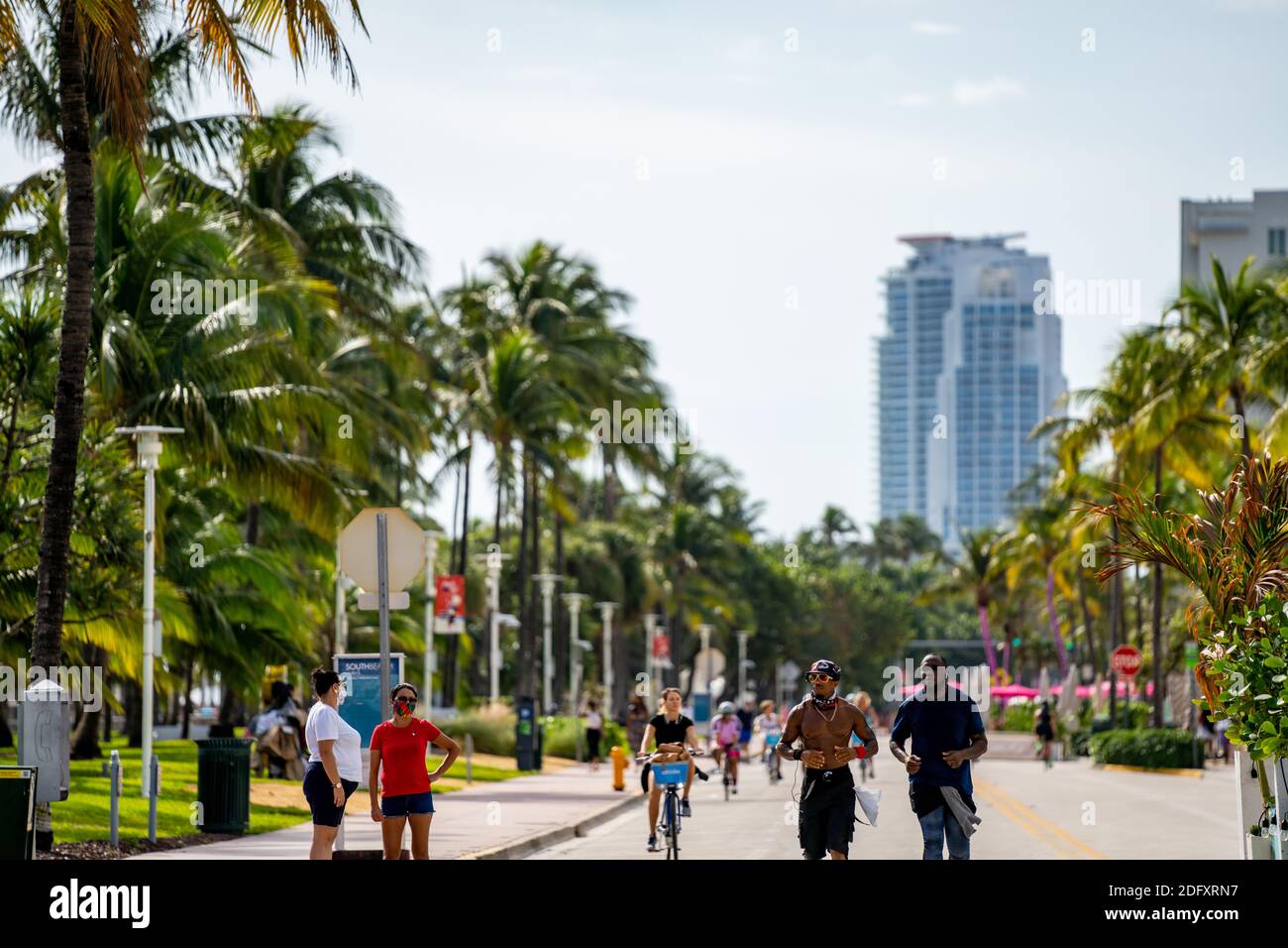 Street photography Miami Beach men running and palm trees Stock Photo ...