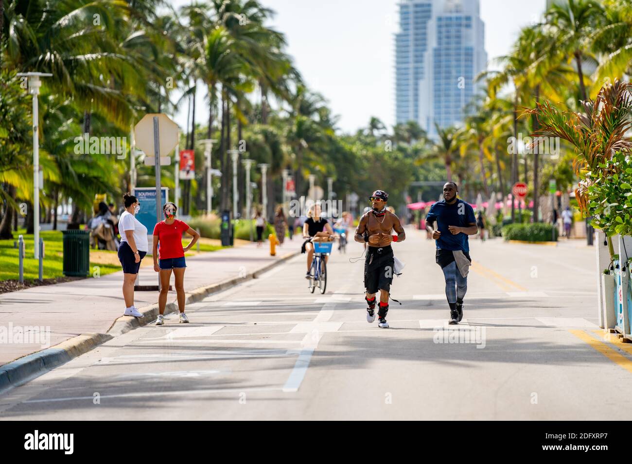 Healthy men running in Miami Beach street photography Stock Photo - Alamy
