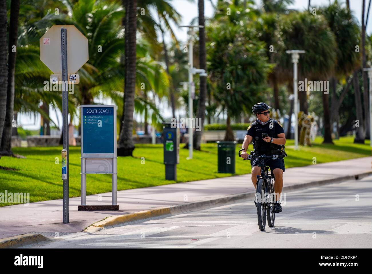 Street photography Miami Beach cop police officer riding a bike Stock ...