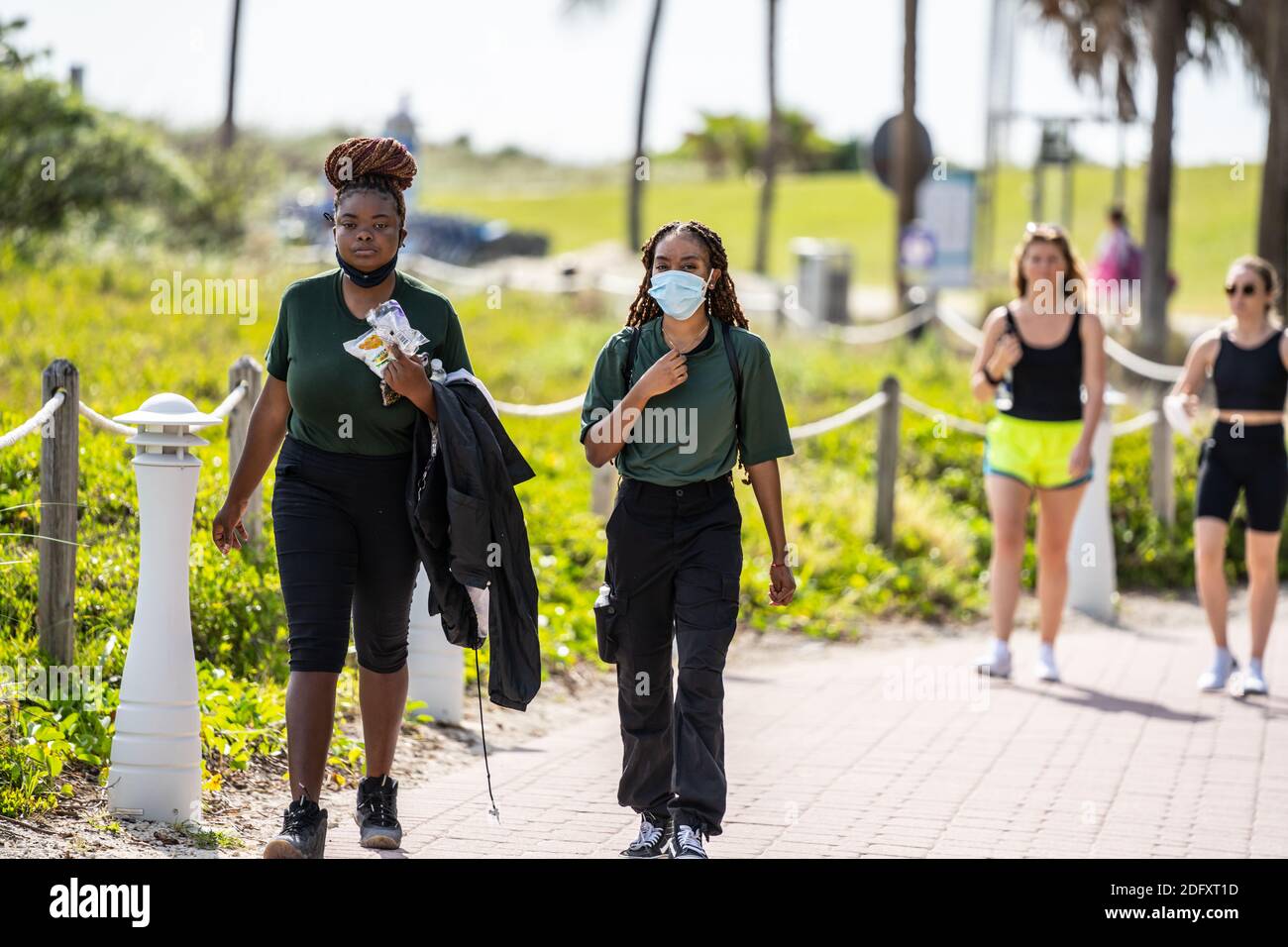 Street photography Young women walking in Miami Beach blurry background ...