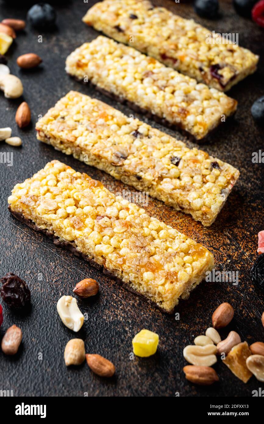 Healthy bars with nuts, seed and berries, on old dark table Stock Photo ...