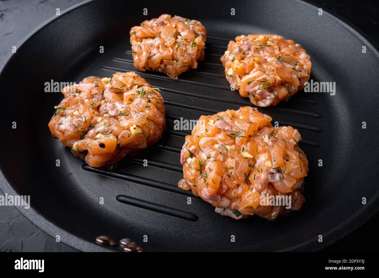 Raw quick asian salmon cutlet, on black textured background Stock Photo ...