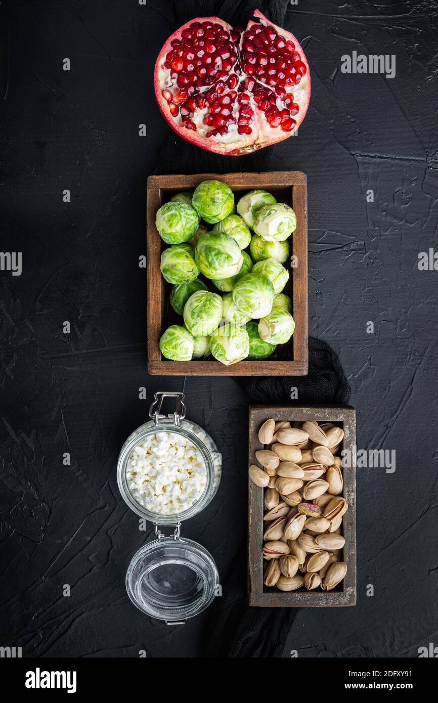 Gnarly garlic brussels ingredient, on black textured background, top ...