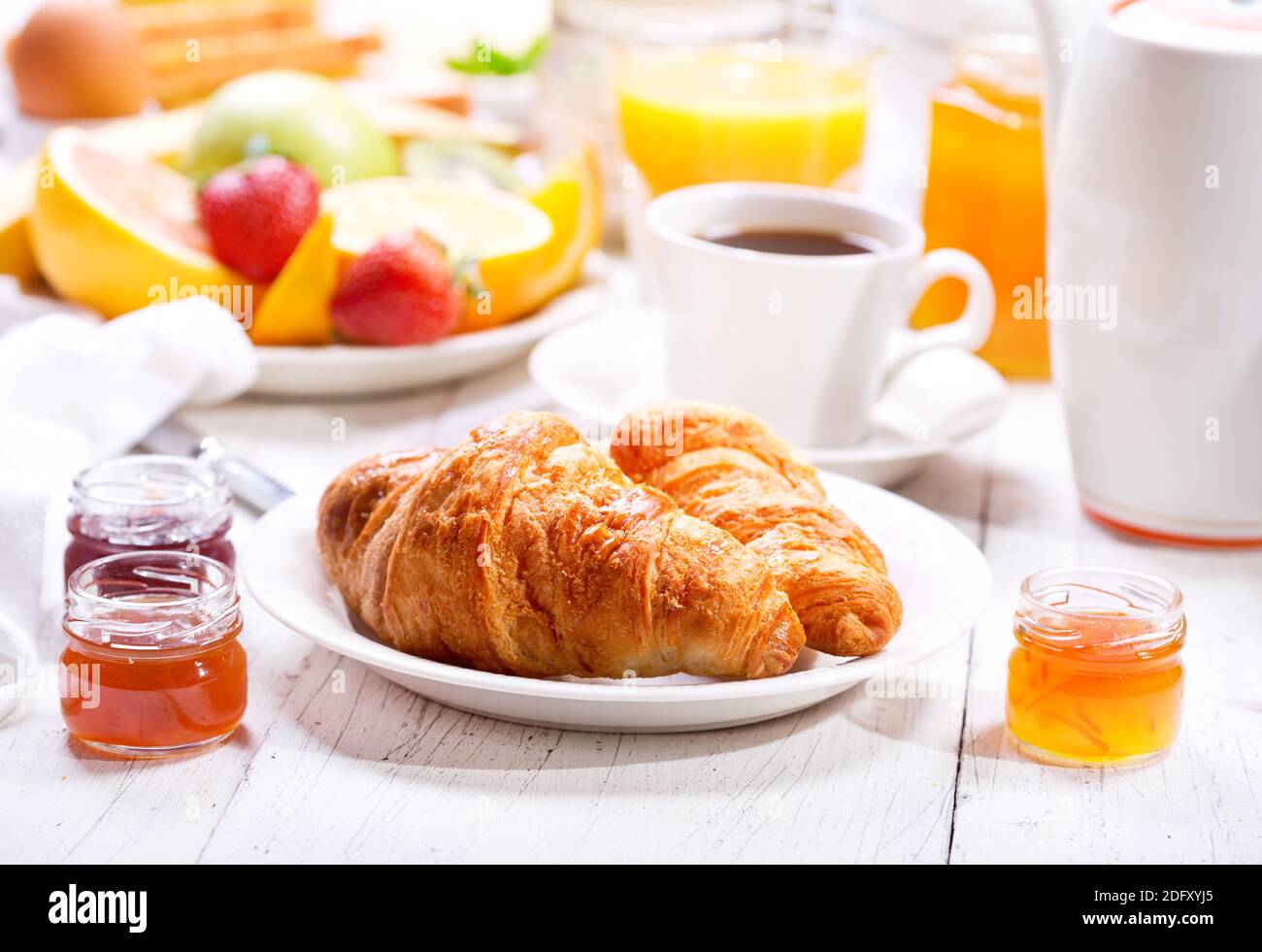 Breakfast table with croissants, coffee, orange juice, toasts and fruits Stock Photo - Alamy
