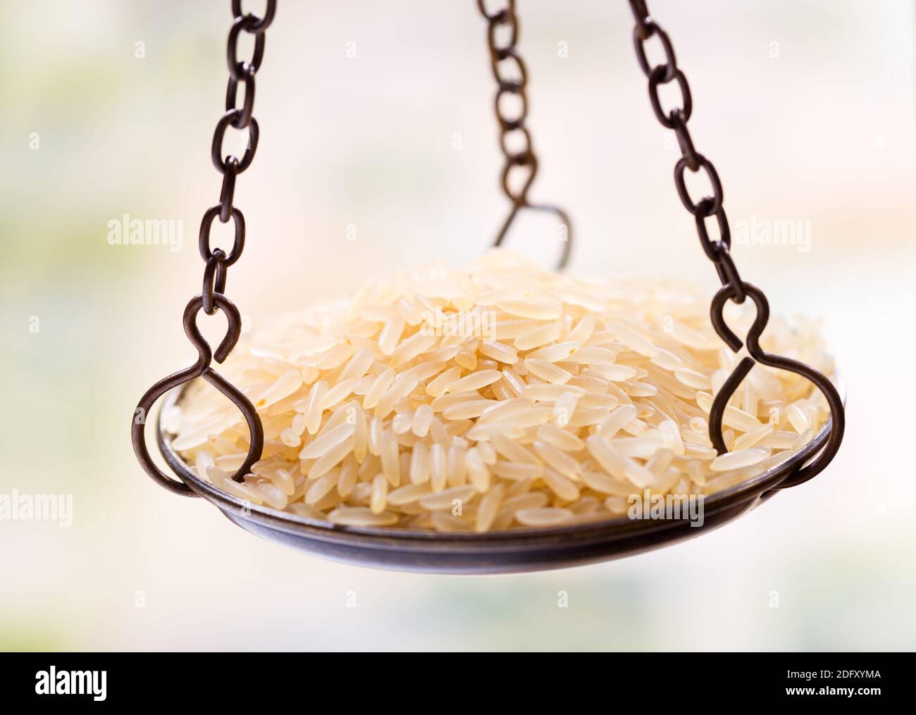 white rice grain in balance scale Stock Photo - Alamy
