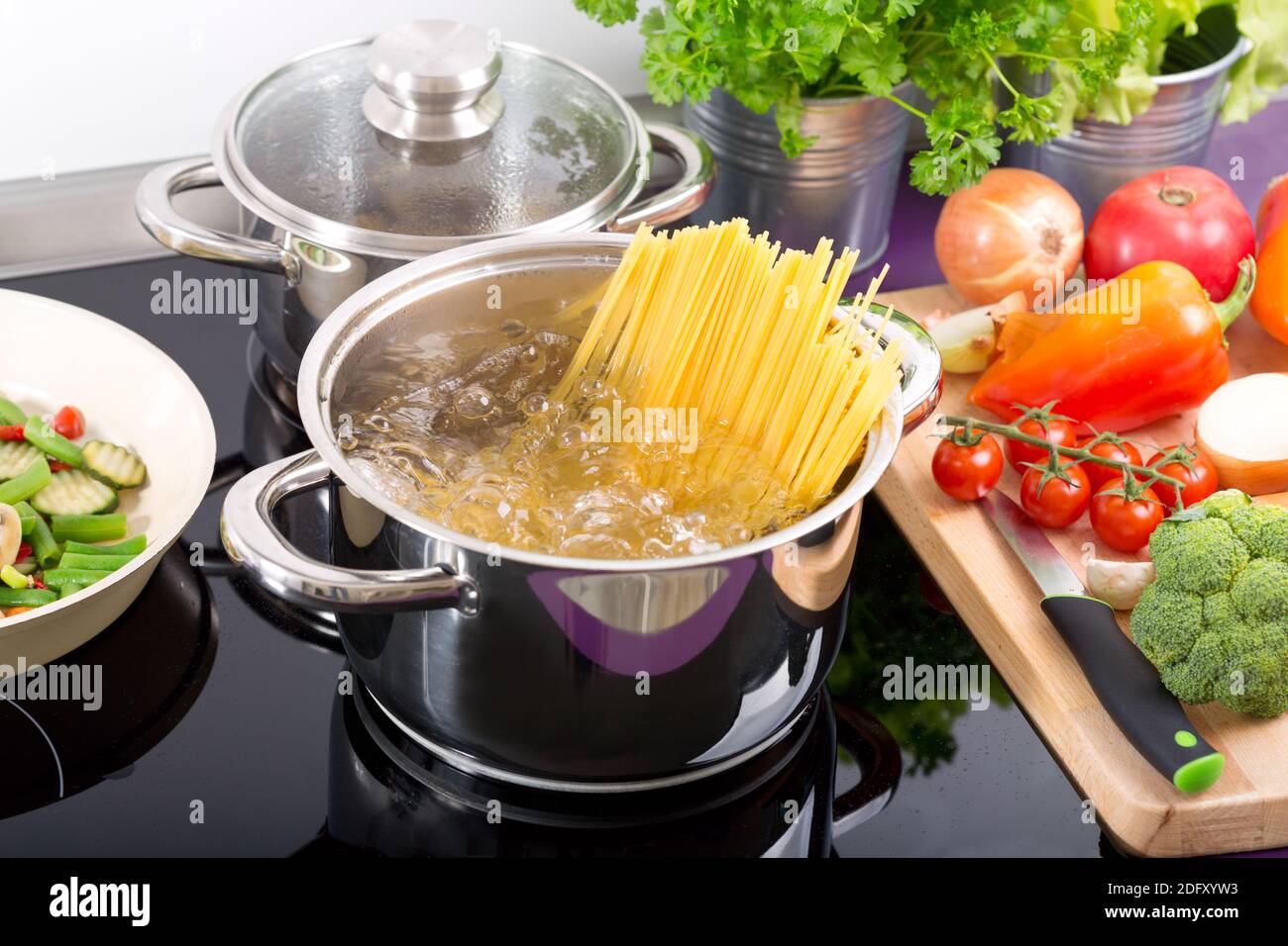 pan of boiling water with spaghetti on the cooker in the kitchen Stock ...