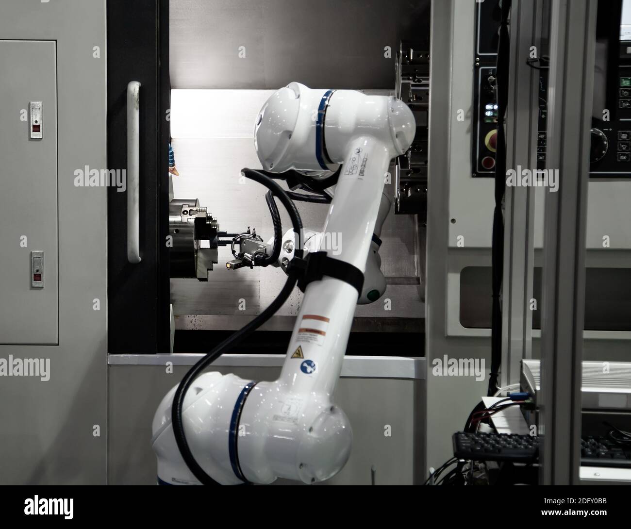 Automated process industrial robot loading metal part to CNC machine ...