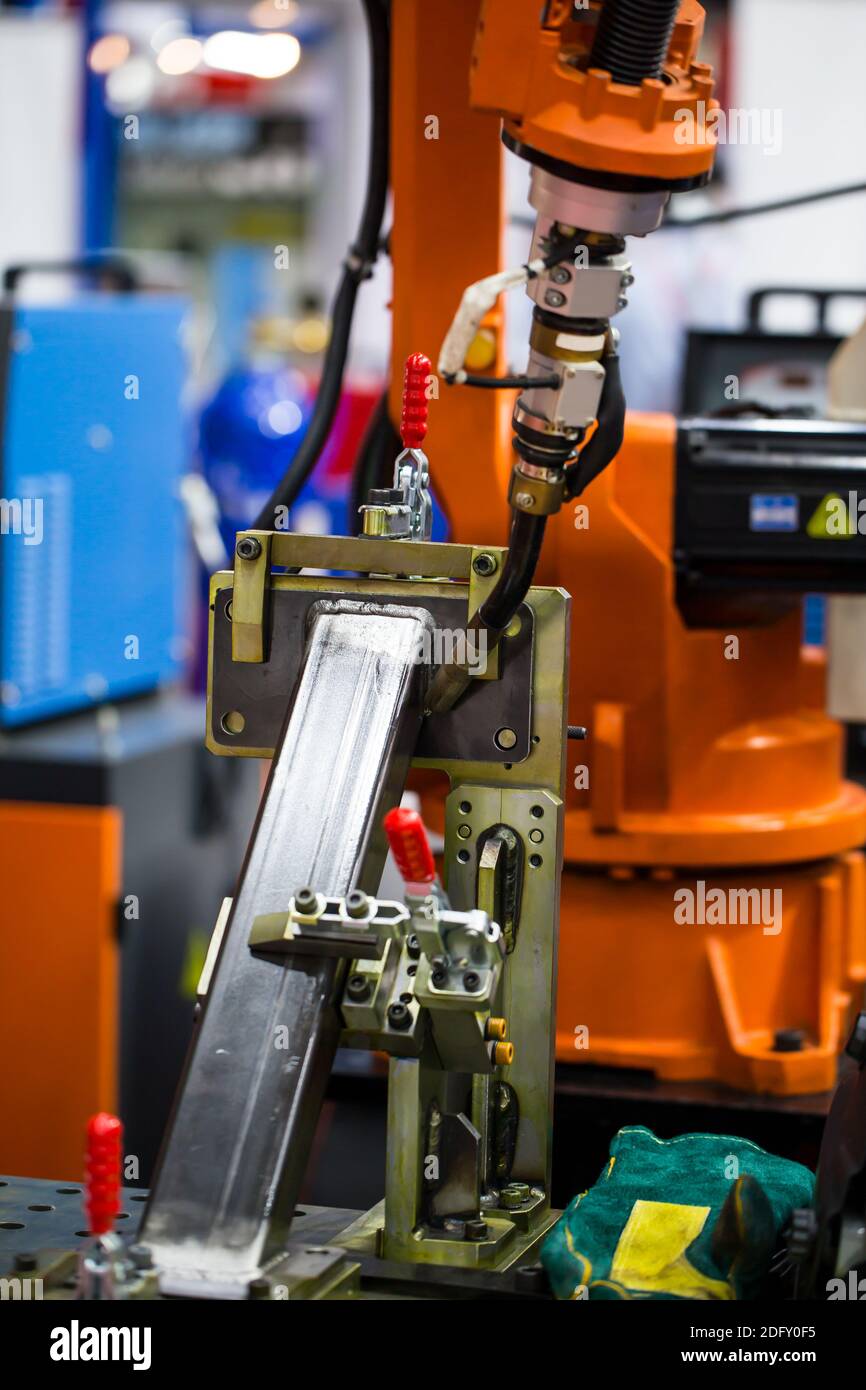 Industrial robot arm welding structural beam in construction heavy ...