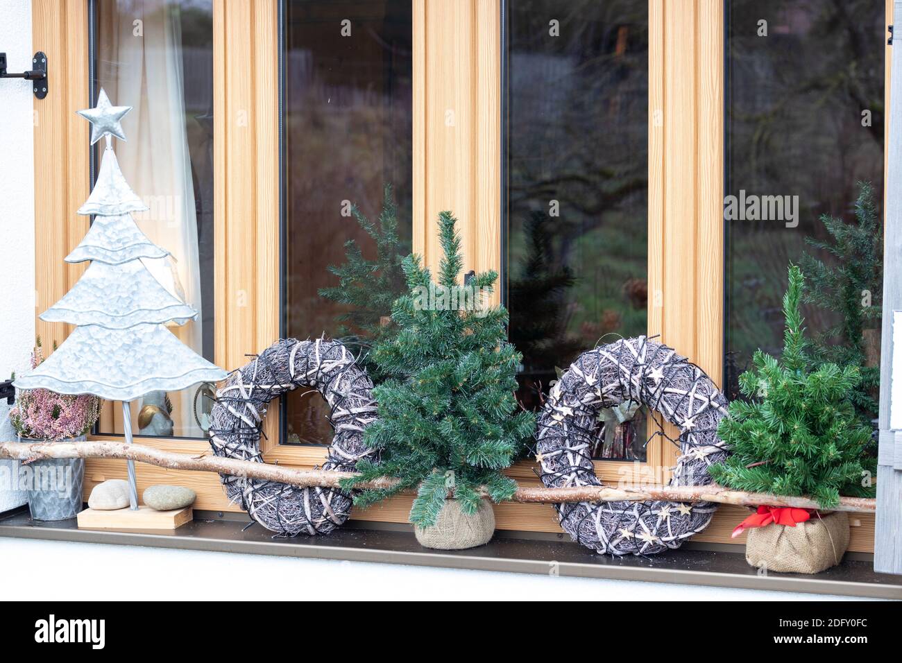 window decorated with christmas trees and willow wreath Stock Photo - Alamy