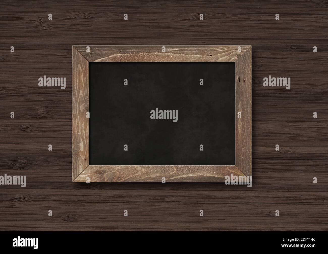Old rustic black board isolated on a dark wooden background. Blank ...