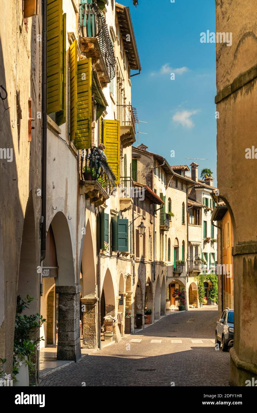 View of the arcades of the ancient village of Asolo in summer, Treviso ...