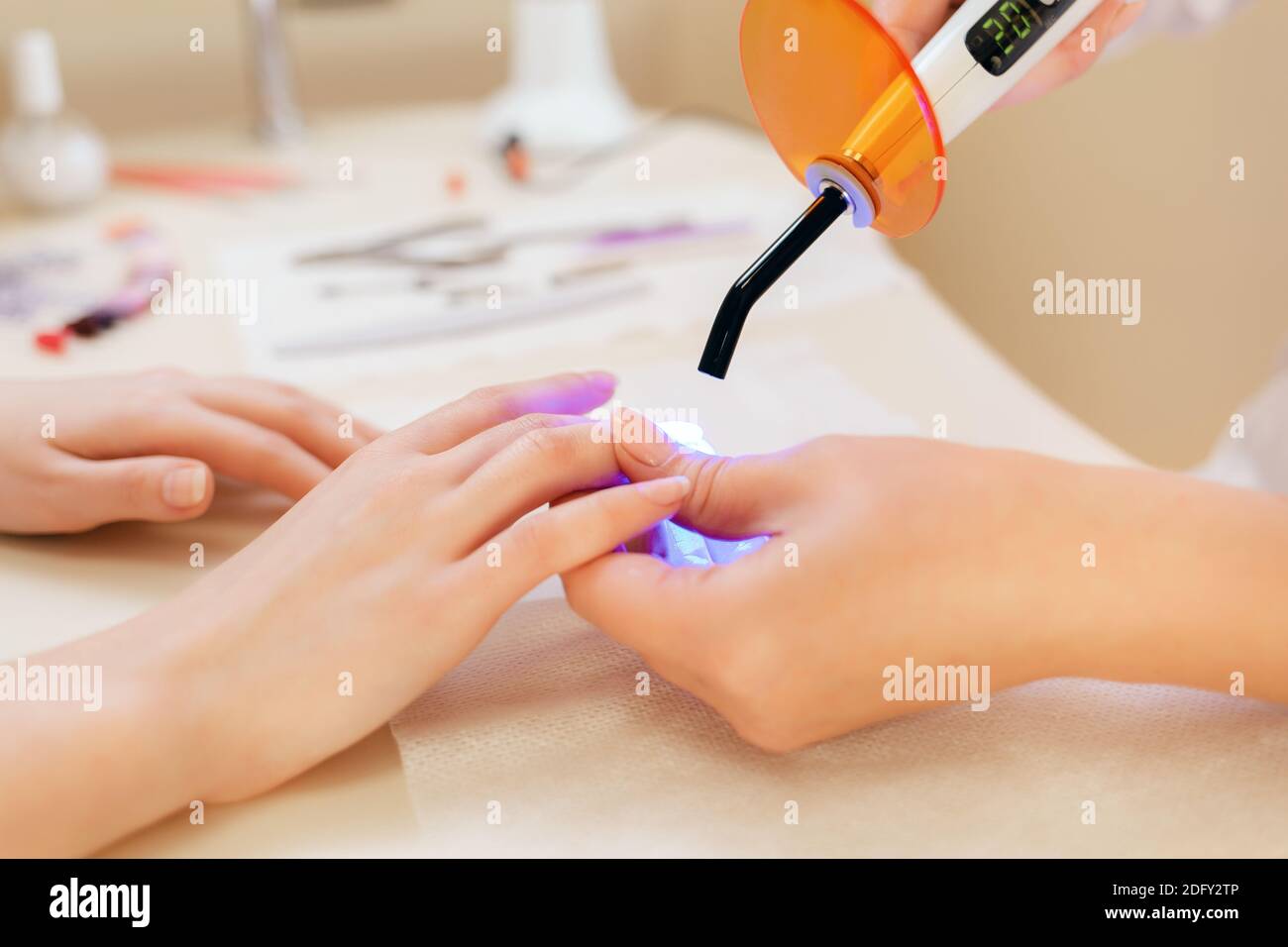Medicine, manicure and prosthetic nail. In the nail salon, a procedure ...
