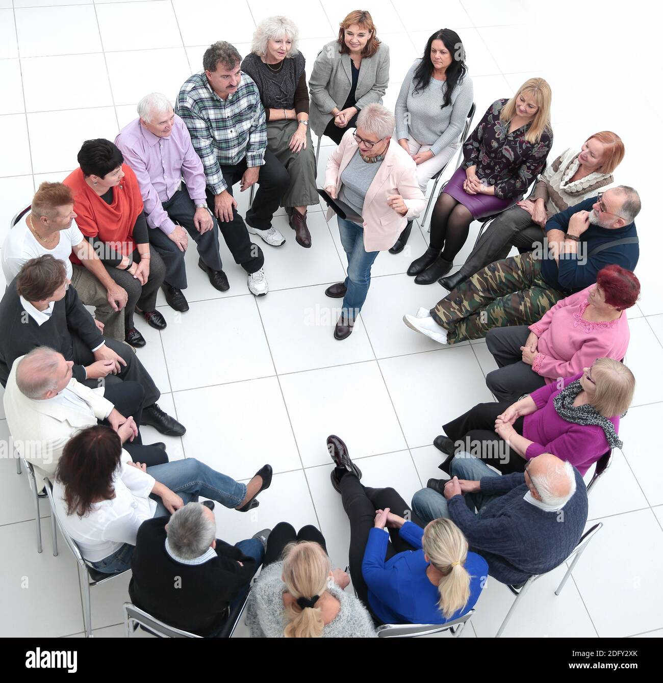 confident older woman standing in a circle of like-minded people Stock ...