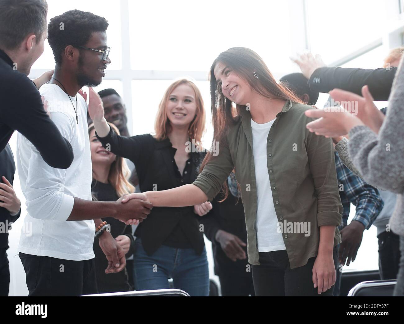 group of happy young people congratulating their colleague Stock Photo ...