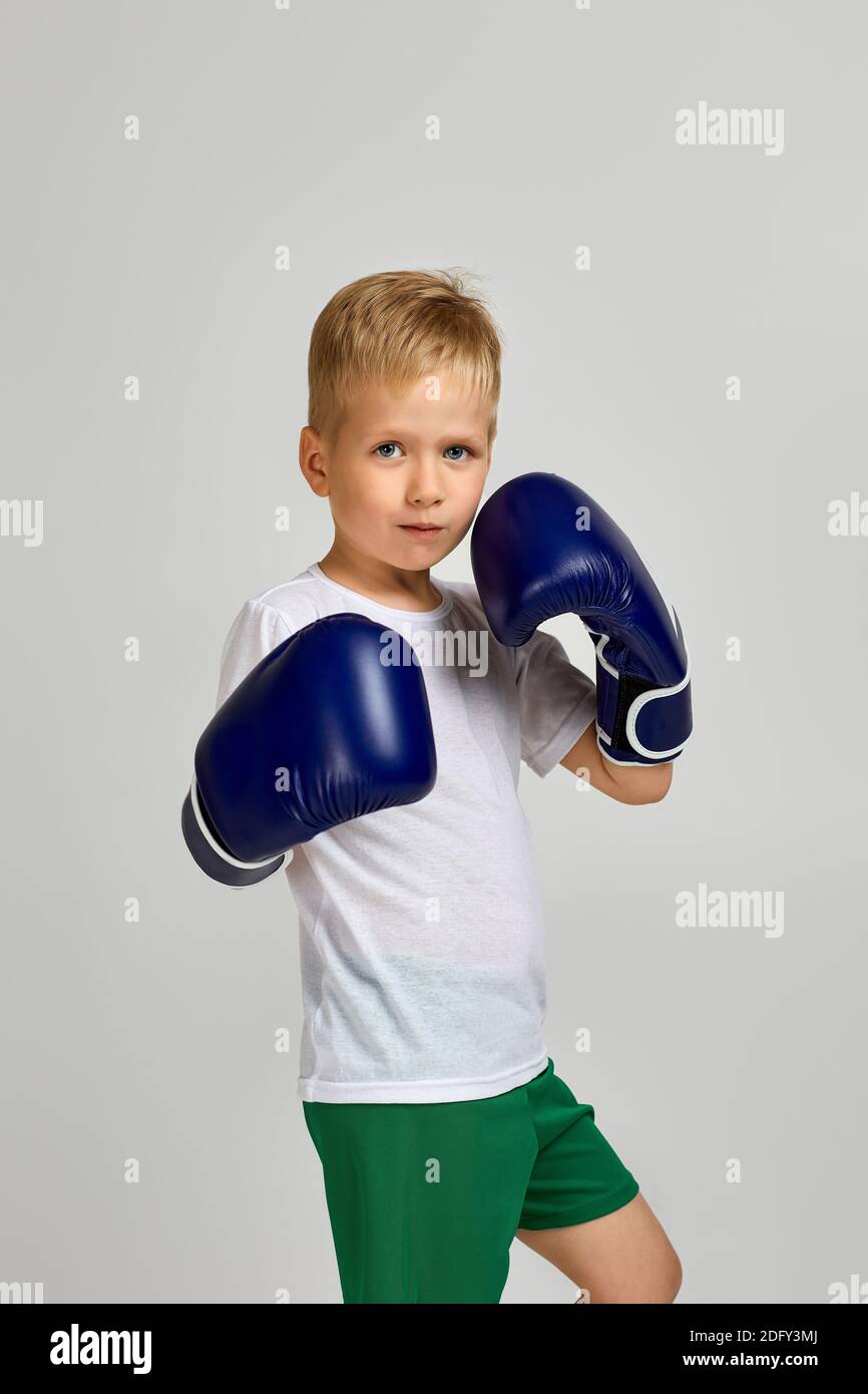 little boxing fighter boy in blue boxer gloves. child dreams of ...