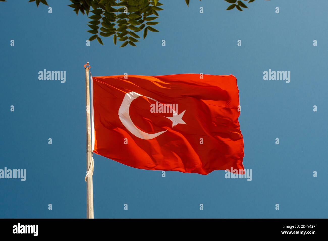 Turkish national flag with white star and moon on a pole in sky Stock ...