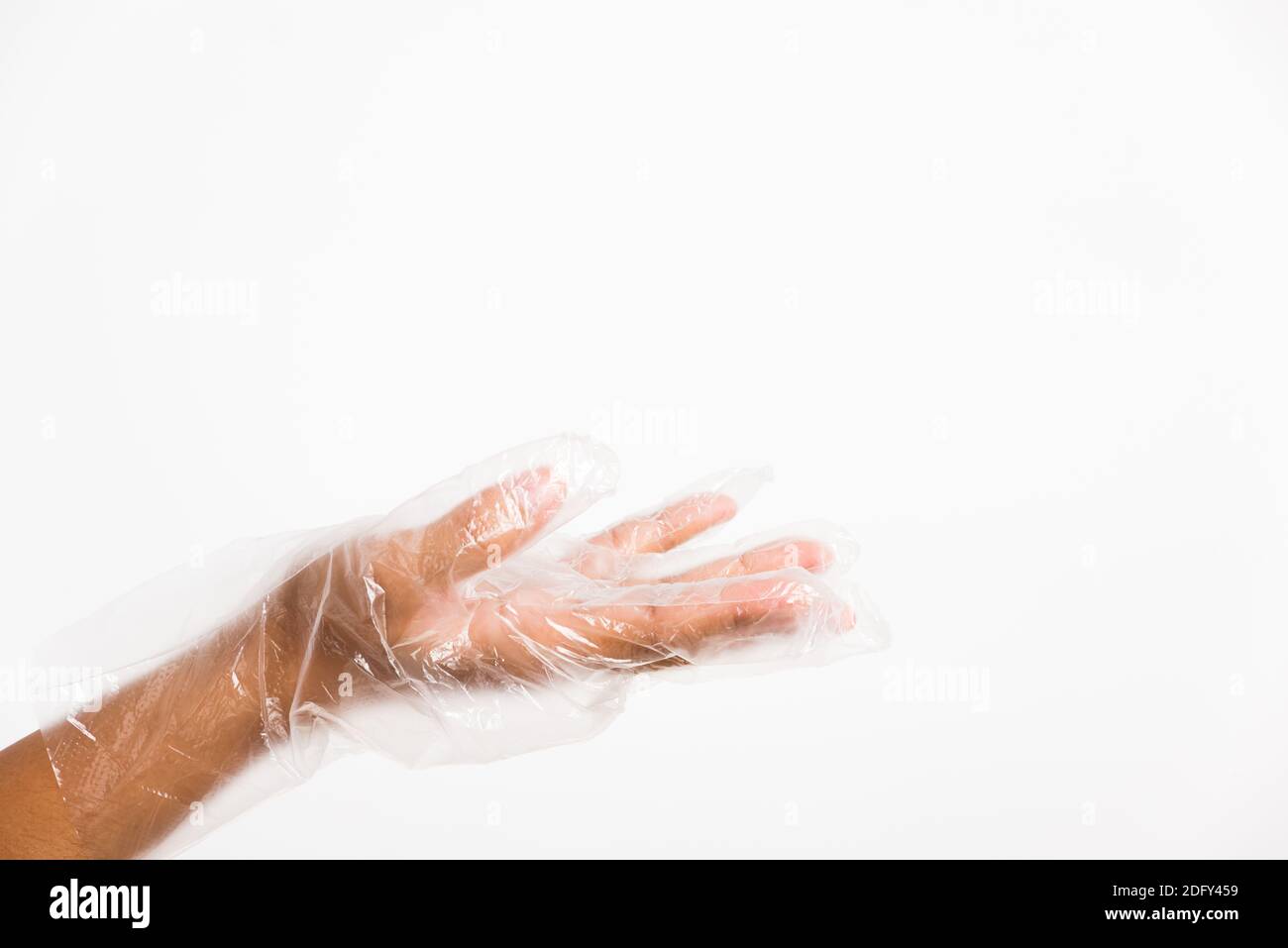 Woman hand wearing single use protect disposable transparent plastic ...