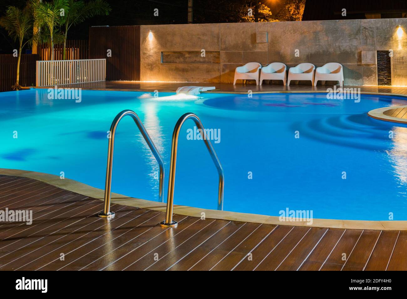 Swimming pool at a luxury resort at night, dawn time Stock Photo - Alamy