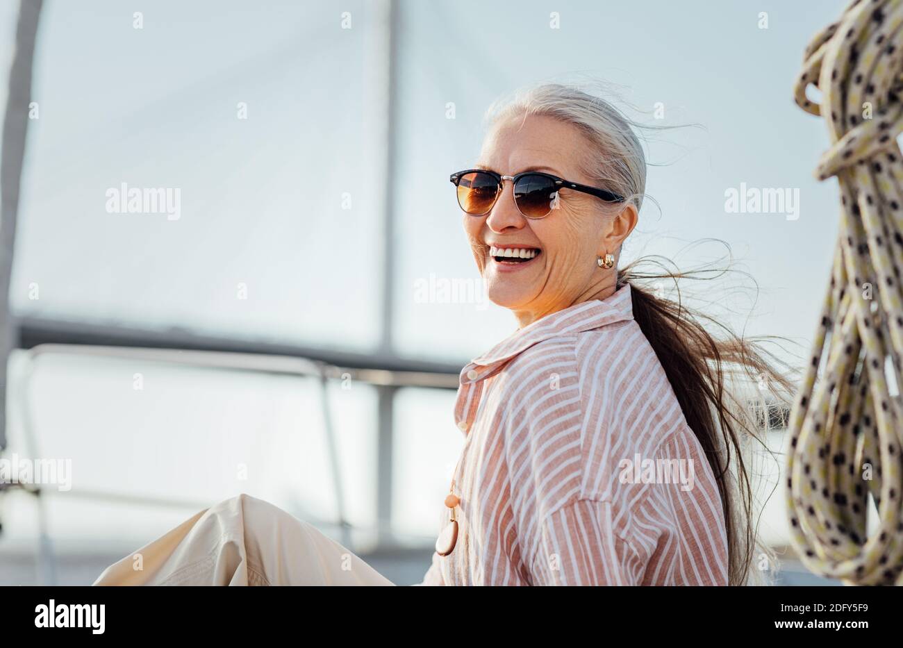 Laughing Mature Woman Wearing Sunglasses And Looking At Camera Stock