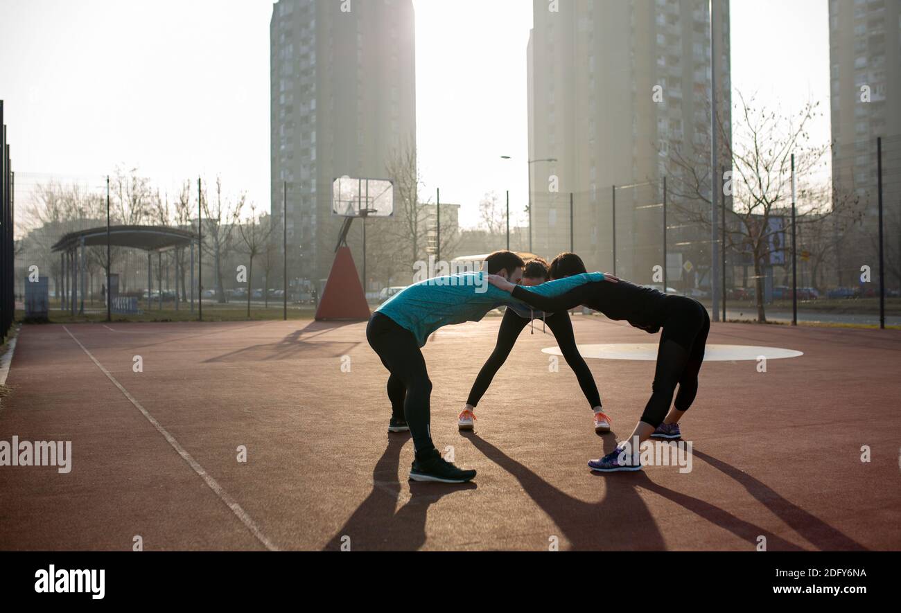 Group of sports friends people are training outdoors Stock Photo - Alamy