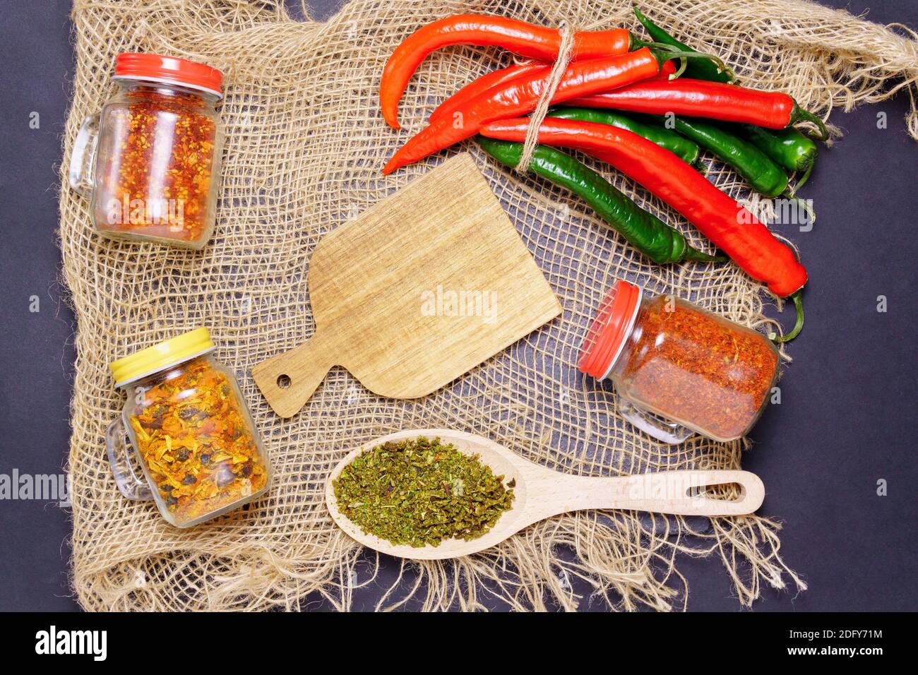 red and green hot chili pepper top view with spices. flat lay ...