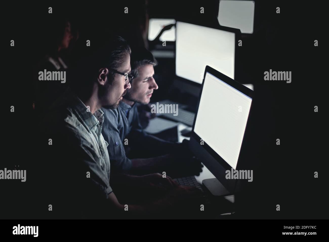 business team works on computers at night Stock Photo - Alamy