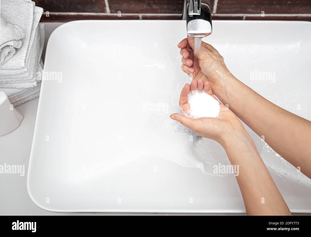 Washing hands with soapy water under running water. The concept of ...