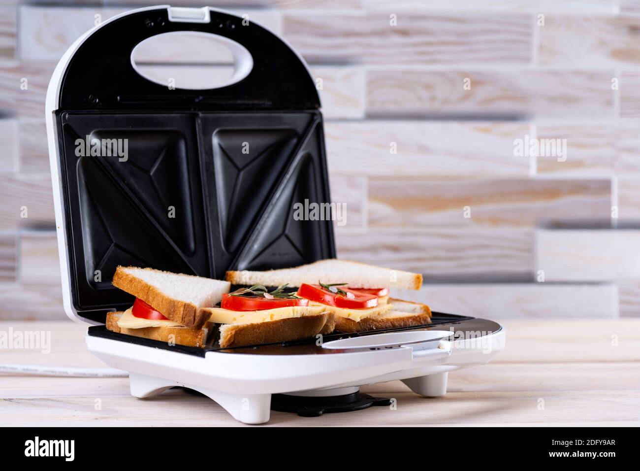 Making Cheese and Tomato Sandwiches on a Sandwich Press Stock Photo - Alamy