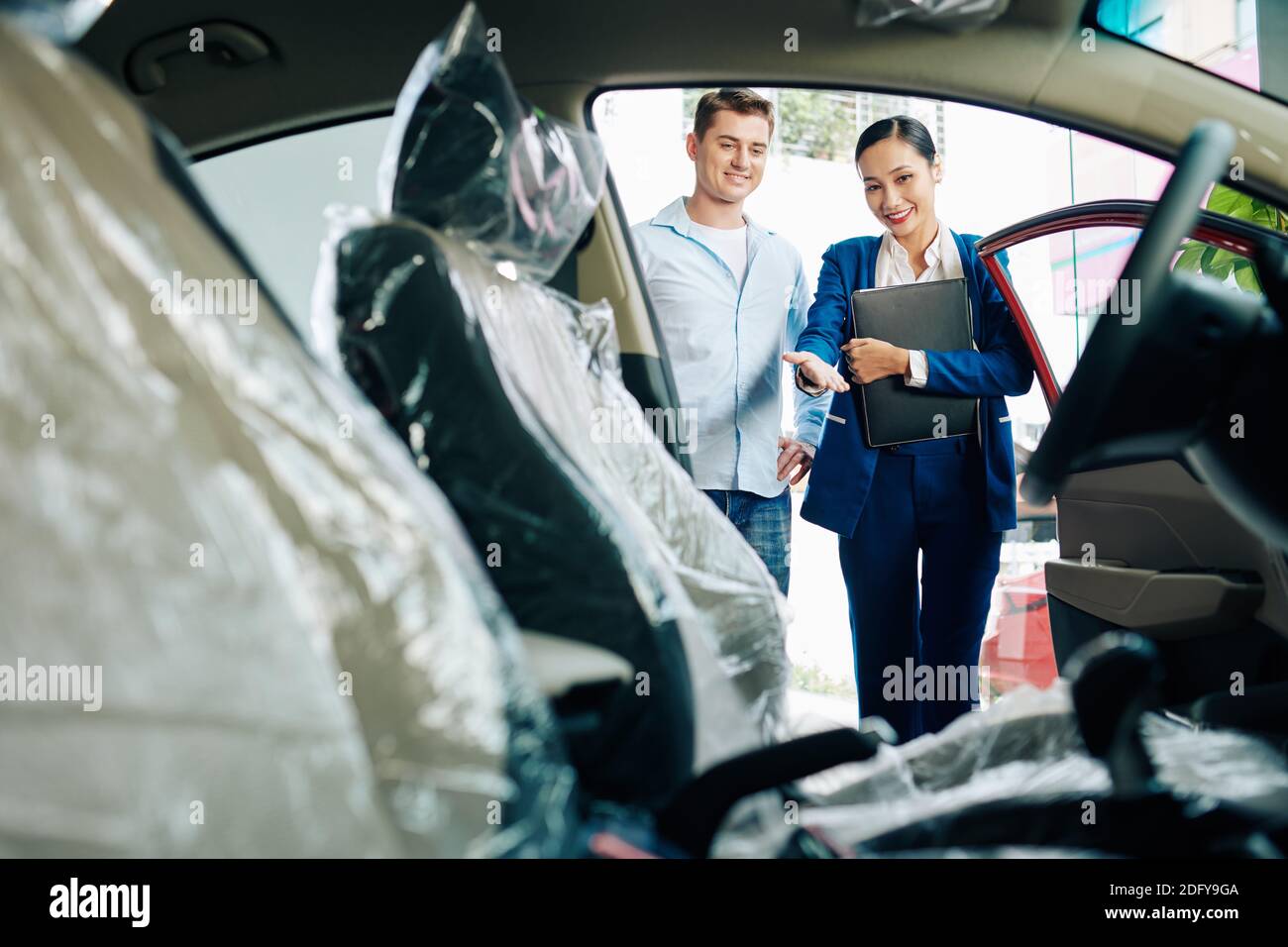 Manager showing car interior Stock Photo - Alamy