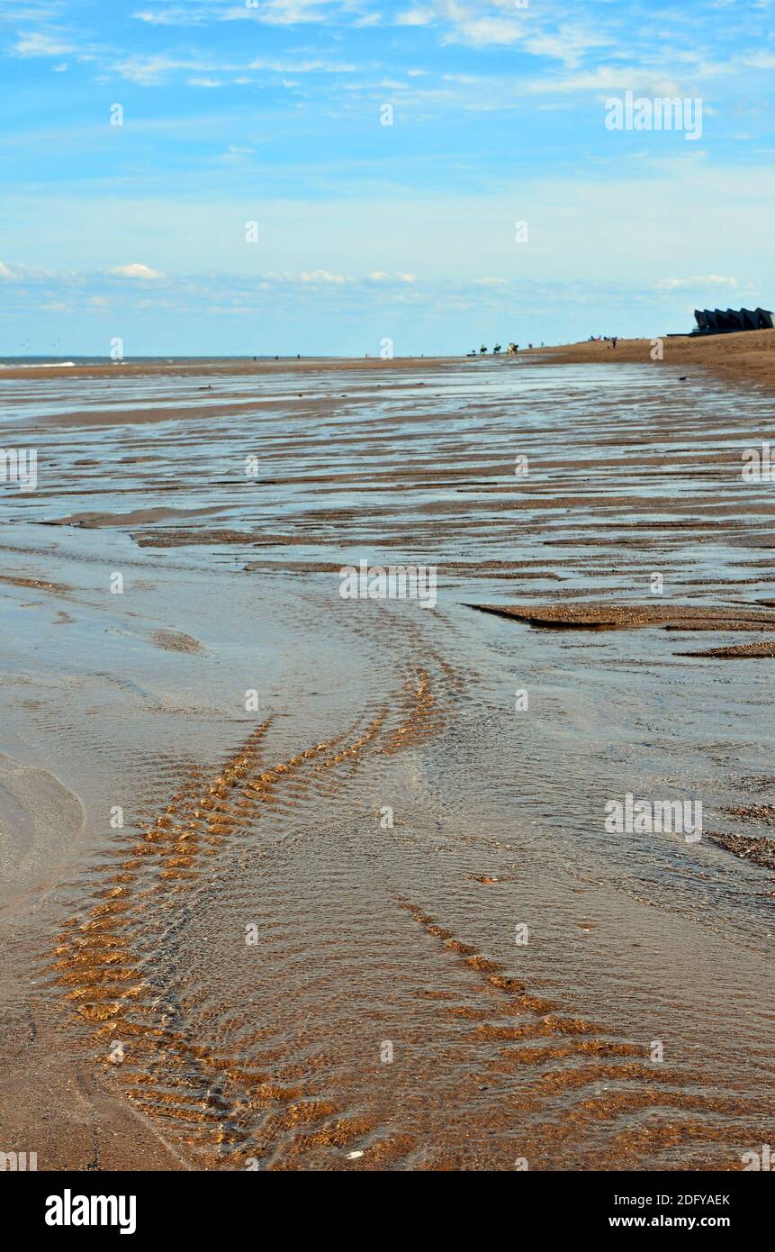 Water forming ripple patterns on the beach as the tide retreats at ...