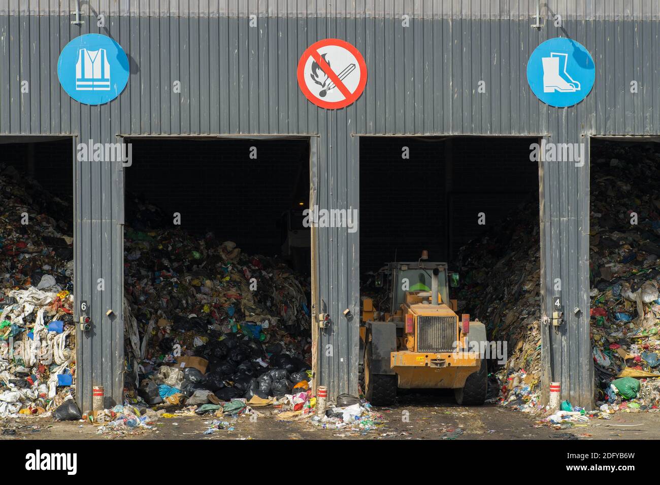 Huge industrial warehouse of household waste. Dump of big city. Yellow ...