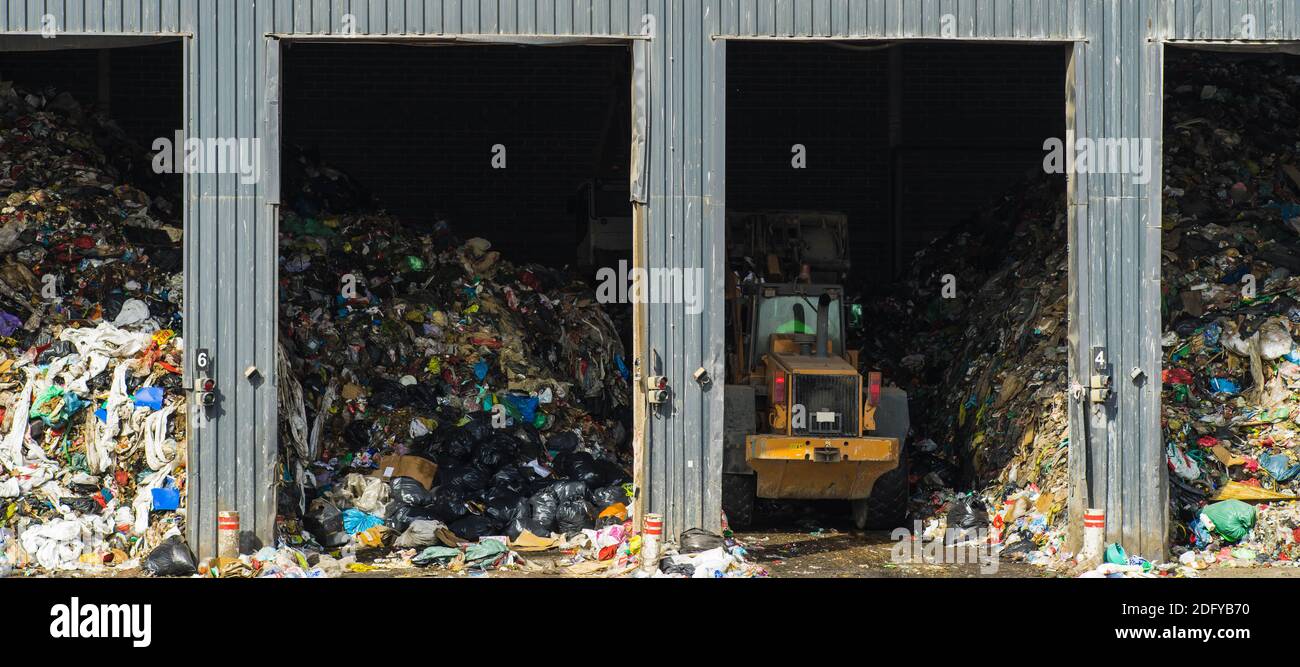 Huge industrial warehouse of household waste. Dump of big city. Yellow ...