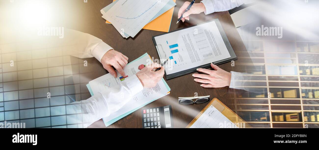 Two business people analyzing charts; multiple exposure Stock Photo - Alamy