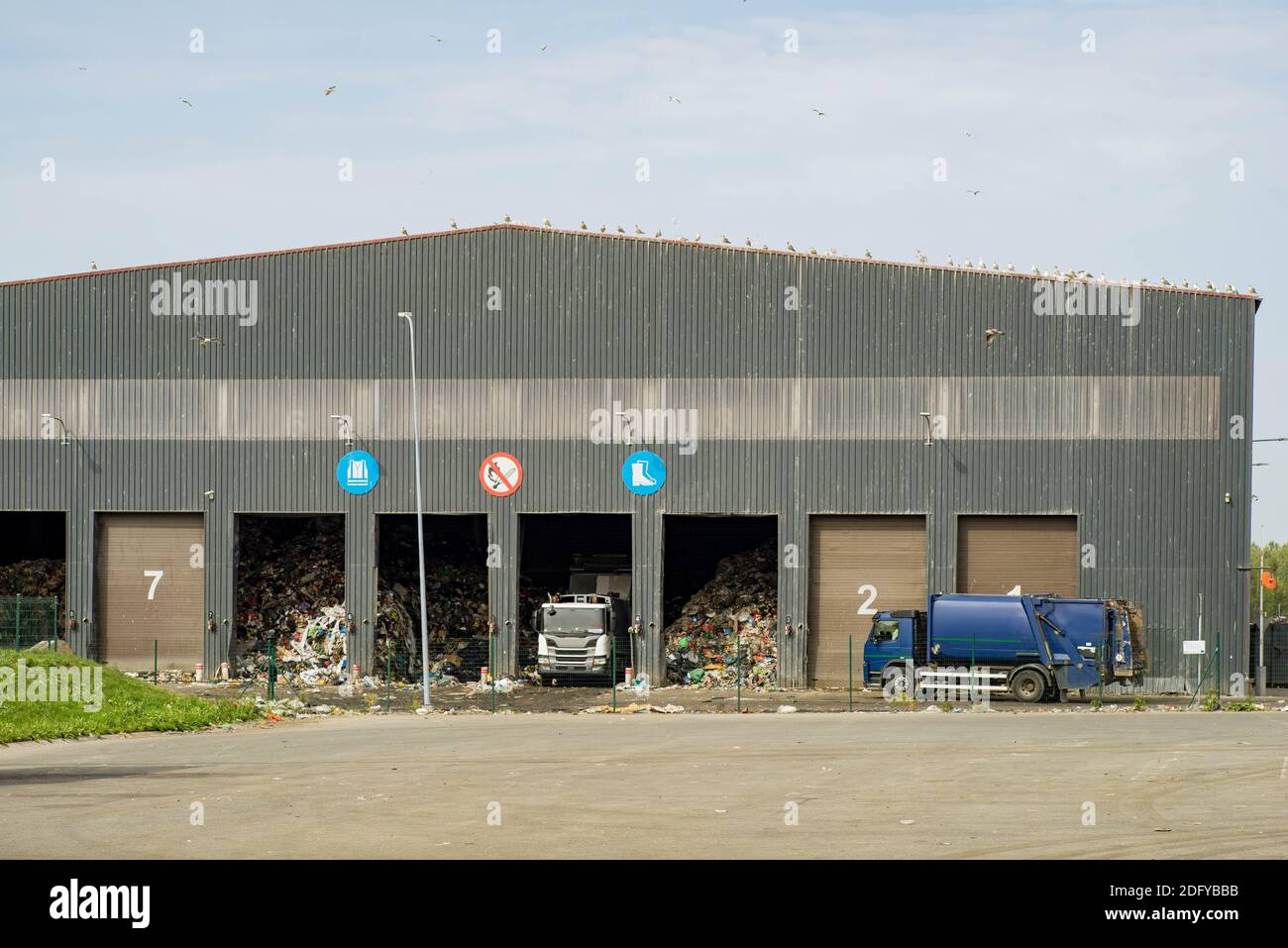 Garbage trucks near warehouse of waste. Dump of big city. Preparation ...