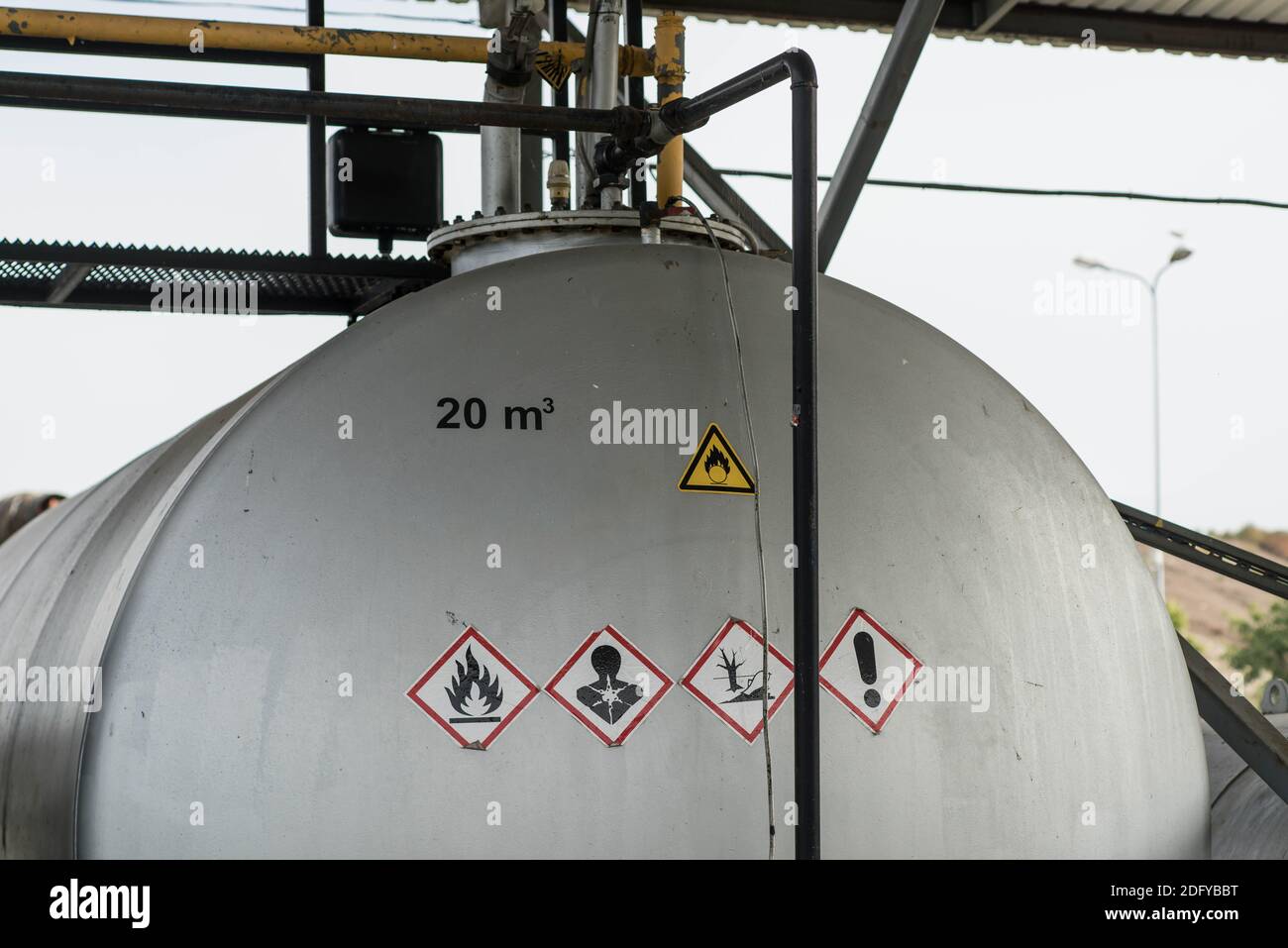 Huge fuel storage tank with danger symbols at gas station Stock Photo ...